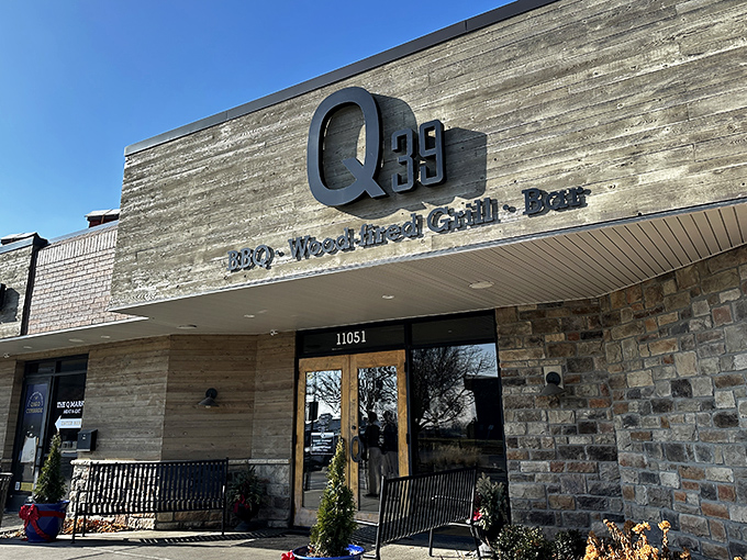 The modern rustic facade of Q39 South beckons like a temple of smoke, where wood and stone promise barbecue enlightenment awaits inside.