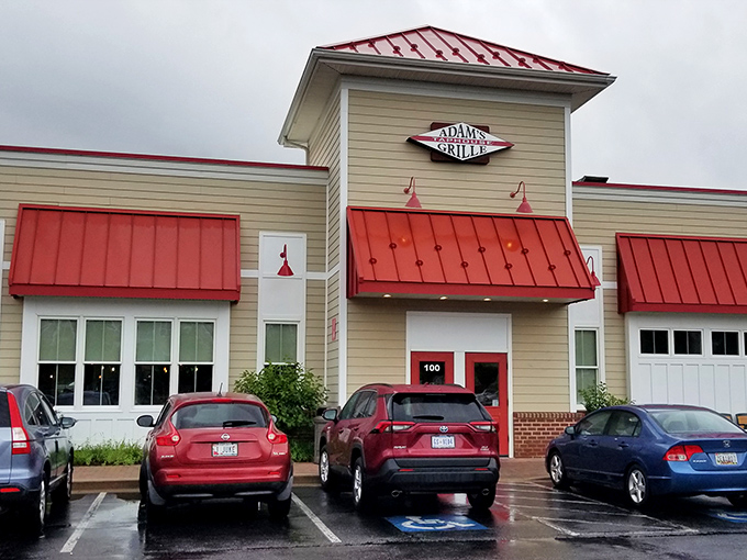 The unassuming exterior of Adams Grille & Tap House with its signature red roof beckons like a barbecue lighthouse guiding hungry travelers home.