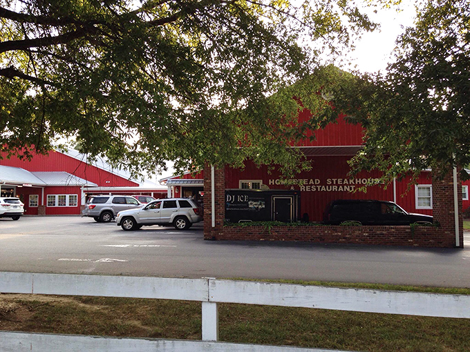 The barn-red exterior of Homestead Steakhouse stands proud against Carolina blue skies, like a beacon calling hungry travelers home. 