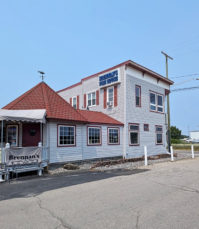 The unassuming white clapboard exterior of Brennan's Fish House stands like a beacon for seafood lovers, its distinctive red-shingled roof a landmark in Grand River.