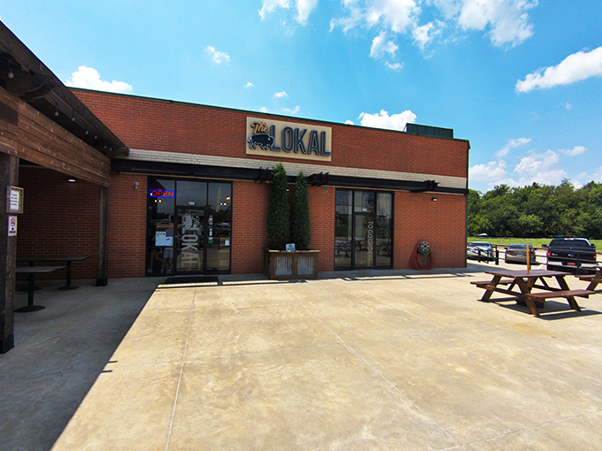 The unassuming brick exterior of The Lokal belies the culinary treasures within. Those two cypress trees stand like sentinels guarding Oklahoma's best-kept secret.