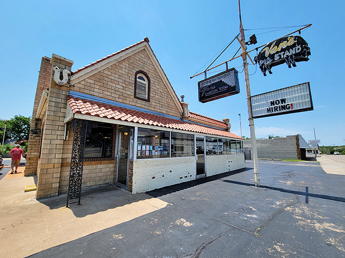 The iconic orange roof and stone exterior of Van's Pig Stand stands as a beacon of barbecue hope on Shawnee's horizon, promising smoky delights within.