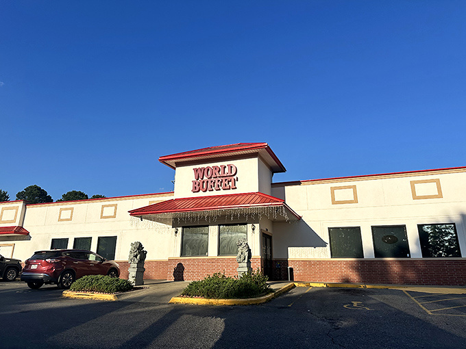 The iconic red-roofed entrance to World Buffet, where stone guardian lions stand sentinel, promising an epic feast within these hallowed walls. 