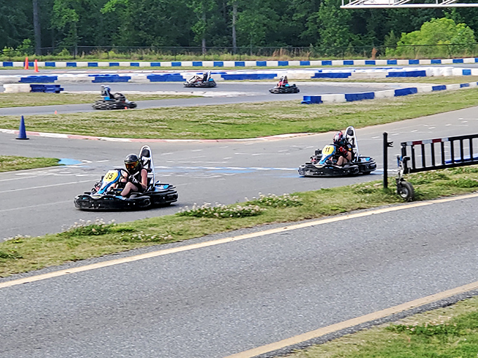 The sprawling track stretches before you like a ribbon of possibility, where everyday drivers transform into racing legends for an afternoon.