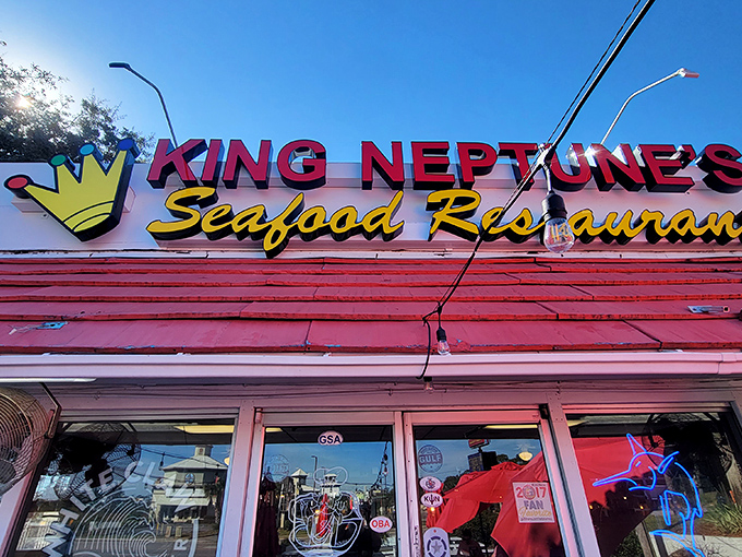 The unassuming exterior of King Neptune's hides culinary treasures within. Those red umbrellas aren't just for show—they're beacons for seafood lovers.