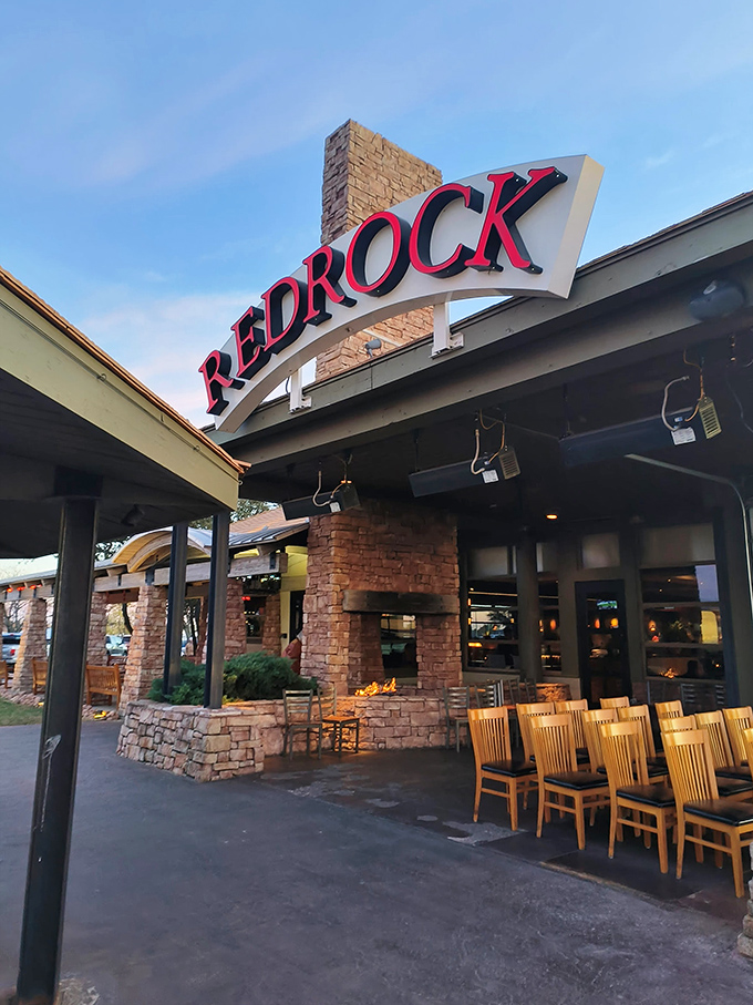 The iconic red REDROCK sign welcomes hungry travelers like a beacon of culinary hope against Oklahoma's big blue sky.