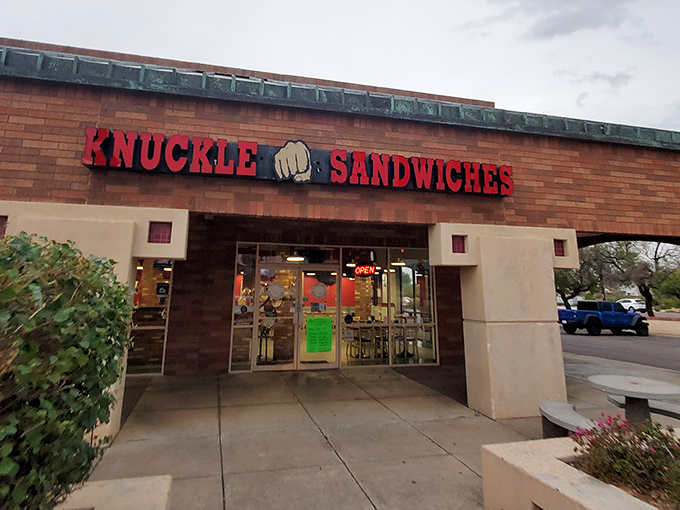 The "NOW OPEN!" banner might be outdated, but the promise of what awaits behind those brick walls is eternally fresh. A sandwich sanctuary beckons.