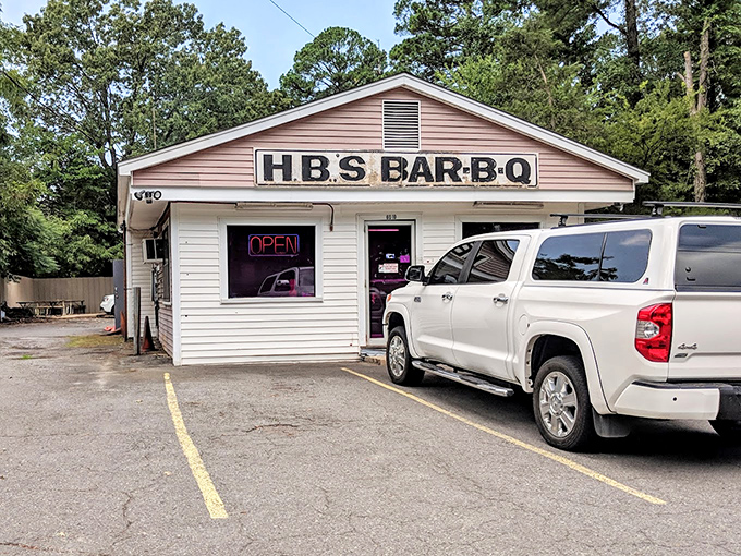 The unassuming white clapboard exterior of H.B.'s Bar-B-Q stands like a beacon to barbecue pilgrims. No fancy frills, just smoke signals of deliciousness within.