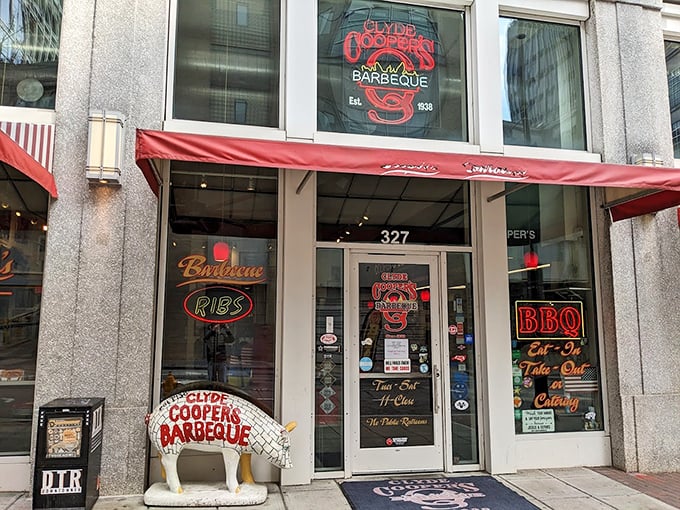 The iconic red awning and pig statue welcome you to Clyde Cooper's, where that neon sign has been promising barbecue bliss since FDR was president.