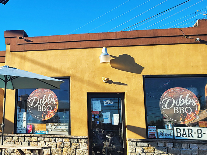 The modest yellow exterior of Dibbs BBQ doesn't scream for attention, but those colorful pennants are like smoke signals beckoning hungry travelers to barbecue paradise. 
