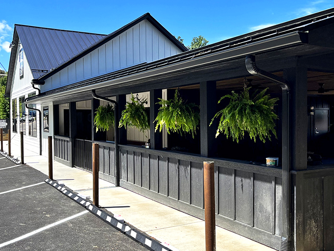 The charming white farmhouse exterior of Secret Sandwich Society stands like a beacon of hope for hungry travelers. Sandwich salvation awaits inside.