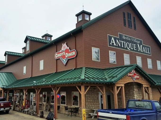 The rustic exterior of Berlin Village Antique Mall stands like a time portal in Ohio's Amish Country, promising treasures within its weathered wooden walls.