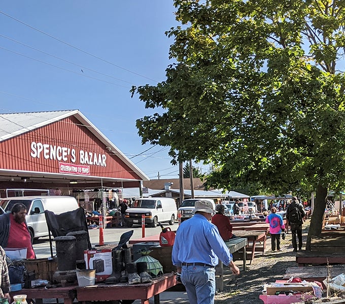 The iconic red facade of Spence's Bazaar stands like a beacon for bargain hunters, promising treasures waiting to be discovered inside and out.