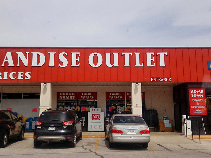 The bright red exterior of Main Street Merchandise Outlet practically shouts "bargains inside!" like a carnival barker with actual deals to offer.