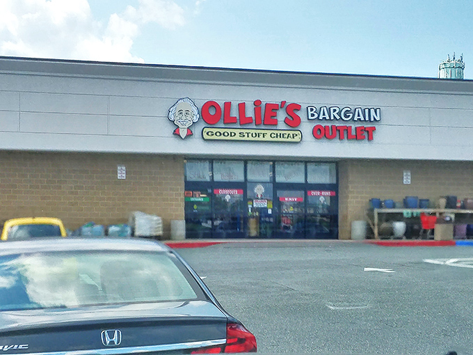 The mothership of markdown magic beckons! Ollie's cartoon mascot grins down at bargain hunters, promising treasures within those unassuming brick walls.