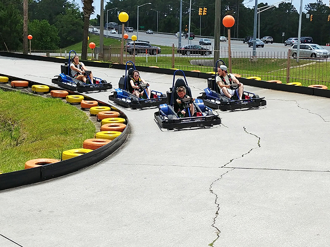 Racing around the bend, these go-karters experience that perfect moment when childhood joy meets adult competitive spirit. Those colorful tires aren't just for show&mdash;they're dream cushions for wannabe NASCAR stars.
