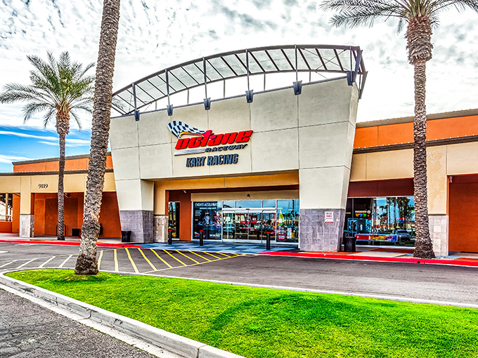 The entrance to Octane Raceway stands like a modern-day coliseum for speed demons, palm trees swaying as if applauding your imminent victory lap.