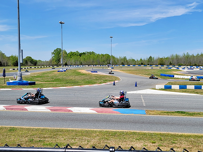 The sprawling track stretches before you like a ribbon of possibility, where everyday drivers transform into racing legends for an afternoon.