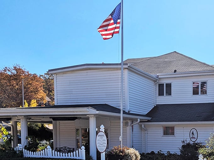 The white clapboard exterior with its American flag and welcoming porch feels like stepping into a Norman Rockwell painting of Southern hospitality.