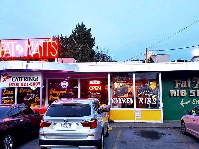 The iconic purple and red exterior of Fat Matt's stands like a BBQ beacon on Piedmont Avenue. Those neon signs aren't lying about what awaits inside.