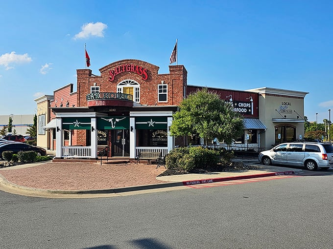 The brick facade of Saltgrass stands like a beacon of hope for hungry travelers. Those flags aren't just decoration&mdash;they're dinner semaphore.