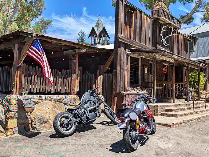 The Old Place stands proudly against the California sky, its weathered wooden exterior and bell tower looking like they've been waiting for John Wayne to ride up.