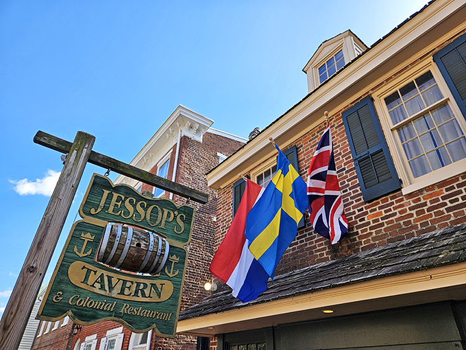 The historic façade of Jessop's Tavern welcomes you with colonial charm, international flags, and that wooden barrel that practically whispers, "Good times await inside."