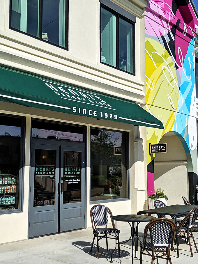 A little slice of heaven with green umbrellas providing shade as diners enjoy their meal on Henri's inviting outdoor patio. The perfect urban oasis.