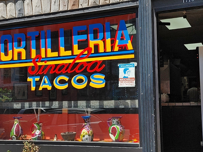 The storefront announces itself with vibrant blue, red, and yellow lettering that seems to say, "Yes, this is the real deal." Colorful ceramic pitchers in the window hint at the authenticity waiting inside.