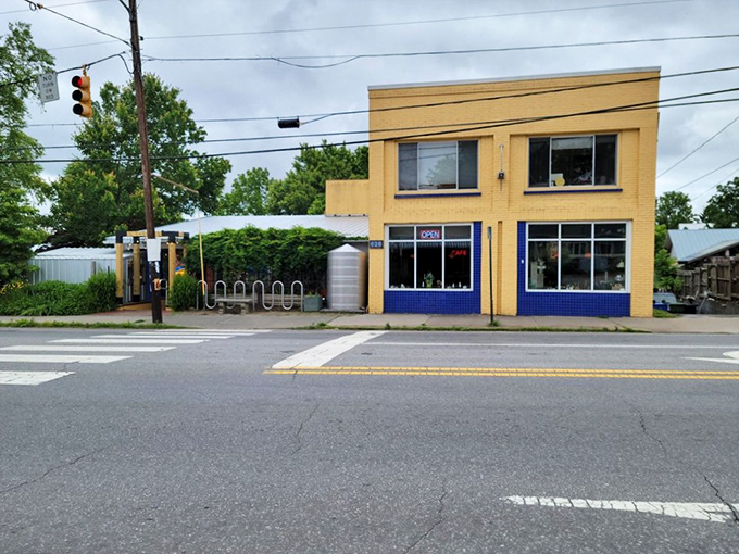 The cheerful yellow exterior of Sunny Point Cafe stands like a beacon of breakfast hope on West Asheville's bustling corridor.