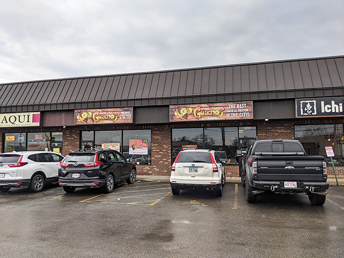 The wooden sign proudly declares "THE BEST TACO AL PASTOR IN THE CITY!" – a bold claim that locals insist might actually be an understatement.