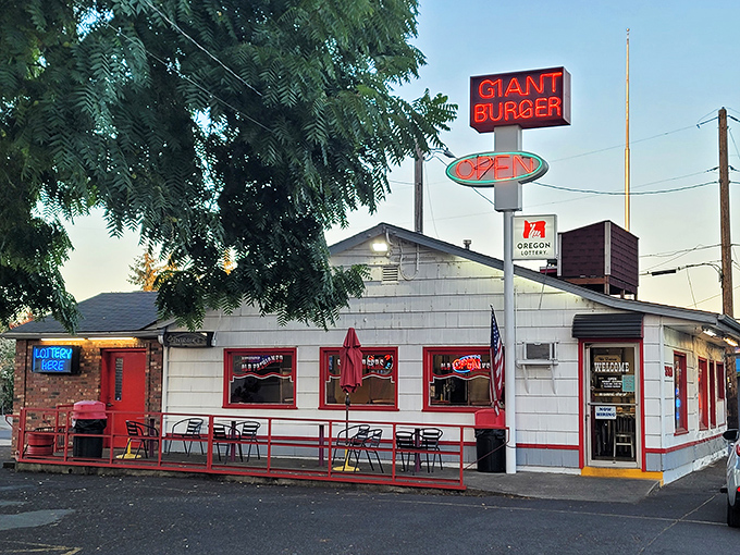 The iconic red and white Giant Burger sign stands tall against the Oregon sky, beckoning hungry travelers like a lighthouse for the famished.
