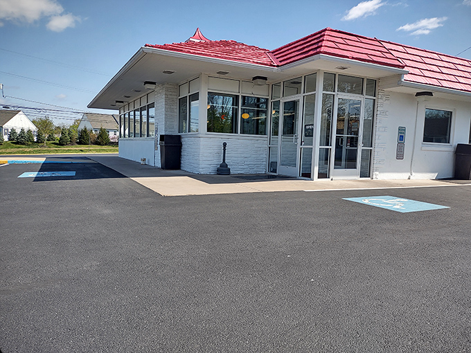 The iconic Speck's sign stands tall against a blue Pennsylvania sky, that dapper chicken in a top hat practically screaming "broasted deliciousness awaits!"