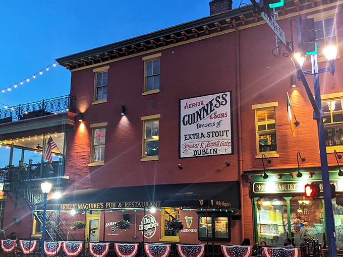 The warm brick exterior of Molly Maguire's glows at twilight, with the iconic Guinness sign promising authentic Irish hospitality within.