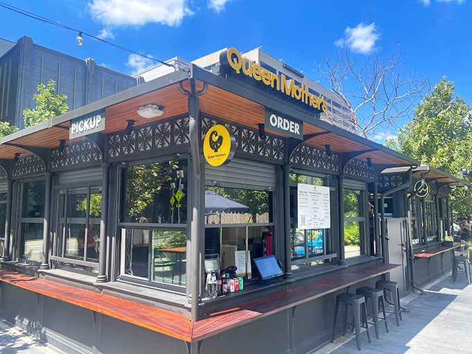 The sleek black-and-yellow exterior of Queen Mother's Kitchen stands like a modern-day chicken temple in Arlington. Simplicity with swagger.