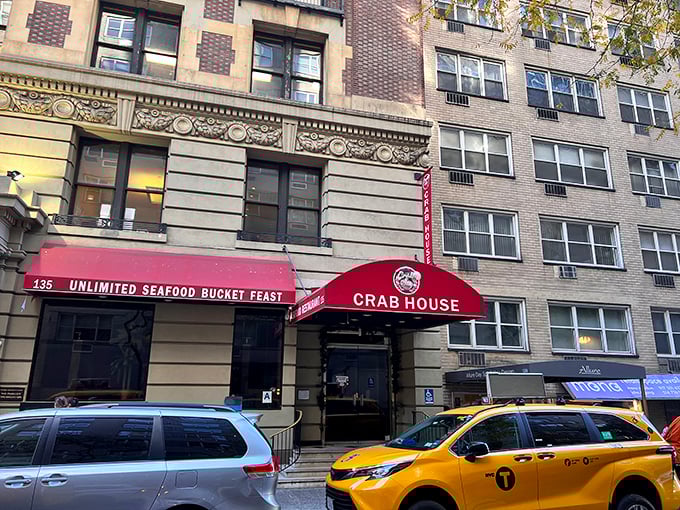 The bright red awning reading "UNLIMITED SEAFOOD BUCKET FEAST" works like a siren call to seafood lovers passing by on Manhattan's streets.