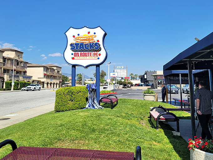 The blue-roofed sanctuary of breakfast dreams awaits on Route 66, where hungry pilgrims find solace in sizzling skillets and coffee refills. 