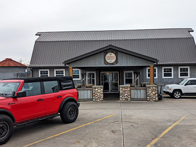 The barn-like facade of The Chubby Trout stands proud with its distinctive silo structure and weathered gray exterior. Rustic charm meets culinary adventure in this unassuming roadside treasure.