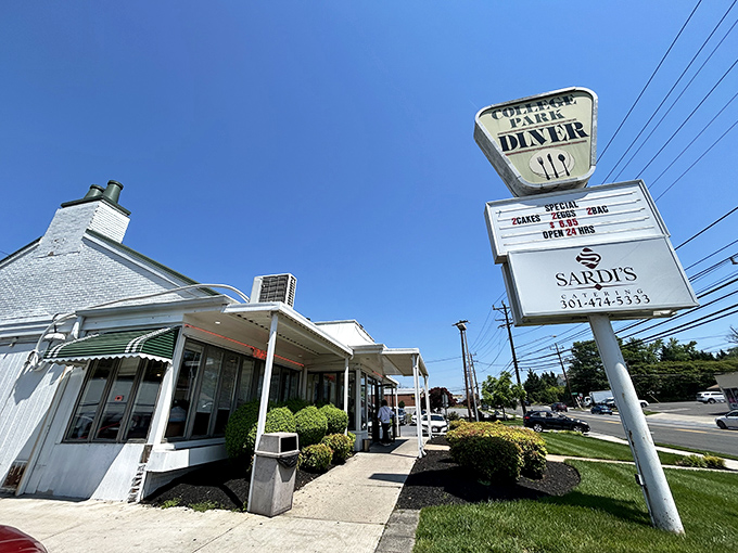 The classic white exterior of College Park Diner stands like a time capsule on Baltimore Avenue, its vintage sign promising comfort food salvation to hungry Marylanders.