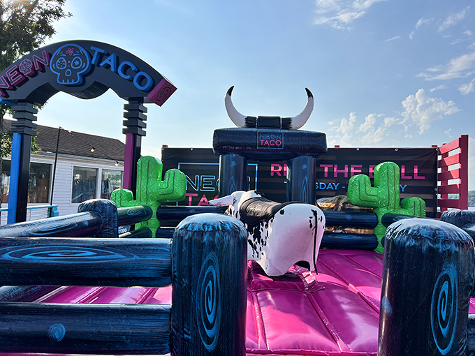 The neon dream beckons from the shoreline, a pink and turquoise beacon promising coastal flavors in the heart of Missouri's lake country.