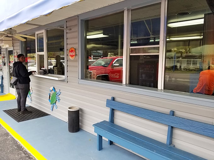 The iconic blue awning and simple sign of Calabash Seafood Hut stand as a beacon for seafood pilgrims. No fancy frills needed when the food speaks this loudly.