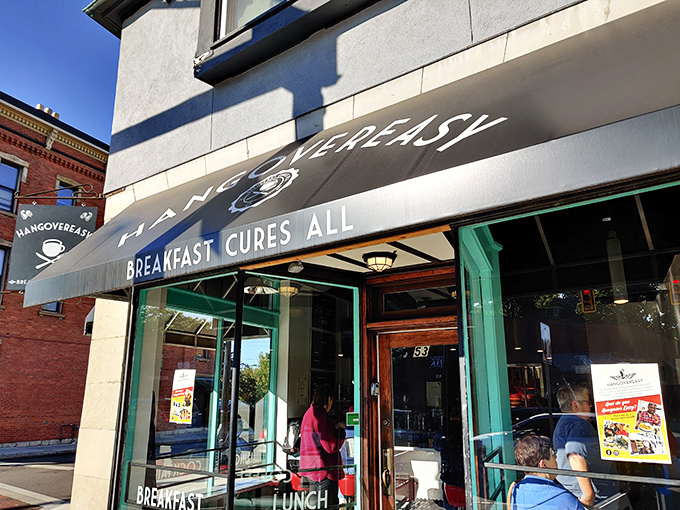 The iconic black awning promises salvation with three simple words: "BREAKFAST CURES ALL." Never has a restaurant sign spoken such profound truth.