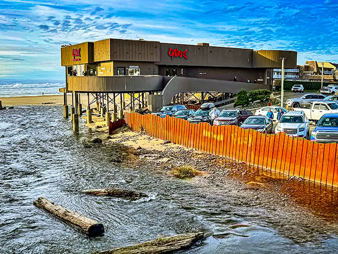 Kyllo's distinctive exterior stands like a modern lighthouse above the beach, beckoning hungry travelers with its glowing red sign.