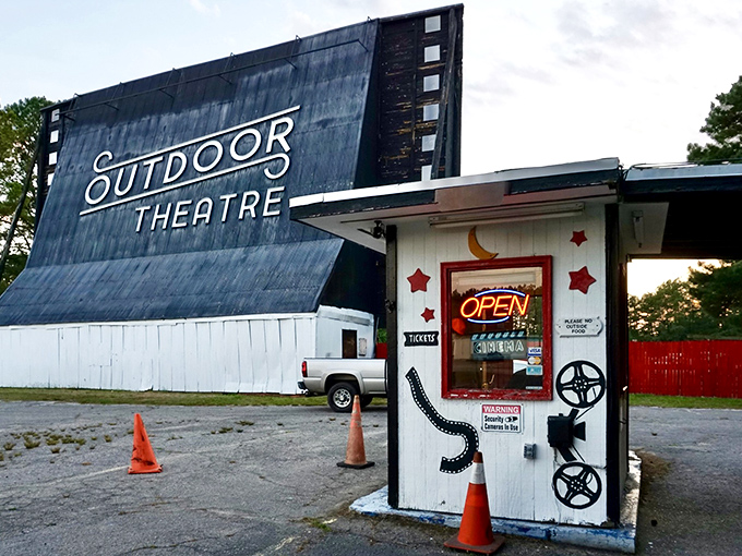 The iconic screen stands tall against the twilight sky, a weathered sentinel guarding decades of cinematic memories. 