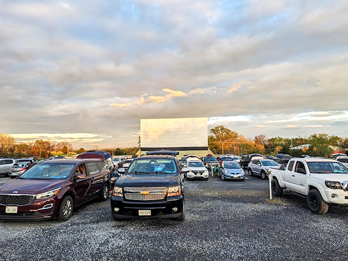 Twilight magic unfolds as cars gather beneath a pastel sky, the massive white screen waiting to transport viewers to another world.