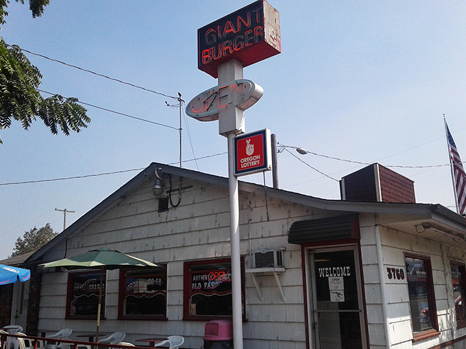 The unassuming white clapboard exterior of Giant Burger stands like a time capsule, its bold red sign promising exactly what generations of Oregonians have come to crave.
