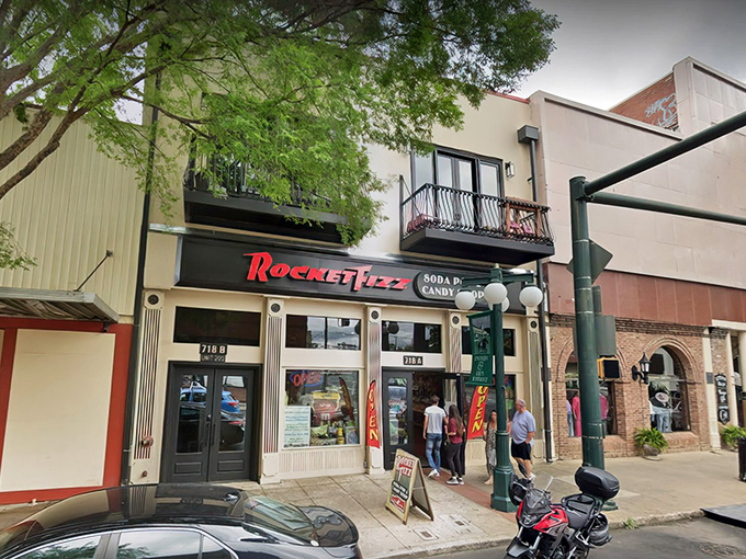 The storefront beckons like a portal to childhood, its bright red sign promising sweet revelations within Hot Springs' historic downtown district.