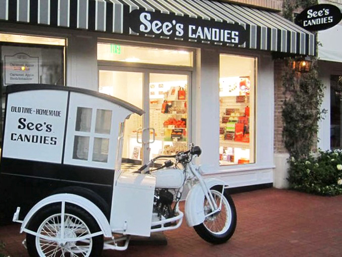 The iconic white building with black trim stands like a temple to sweetness, beckoning chocolate pilgrims with its timeless charm.