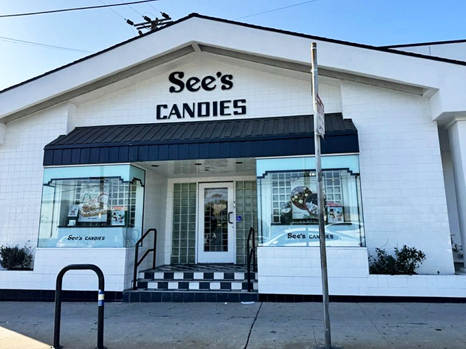 The iconic white building with black trim stands like a temple to sweetness, beckoning chocolate pilgrims with its timeless charm.