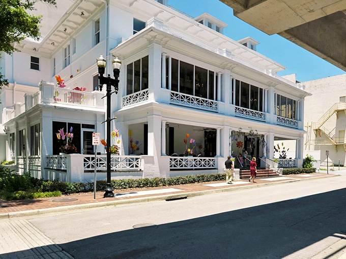 The grand white mansion housing Sweet Pete's stands like a sugar palace against Jacksonville's blue sky, promising sweet adventures within.
